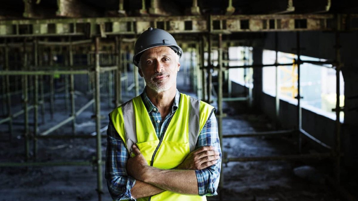 Construction Worker Standing Near Scaffolding Stock Photo | Lewis ...